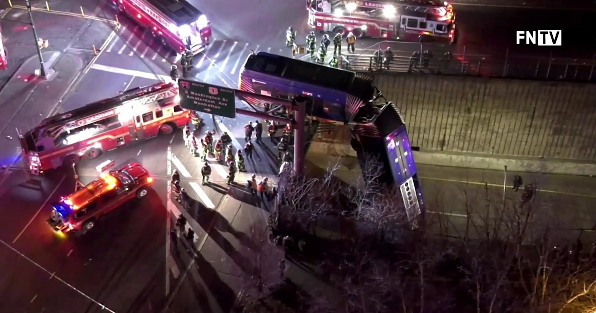 Bus dangles off roadway after veering off overpass