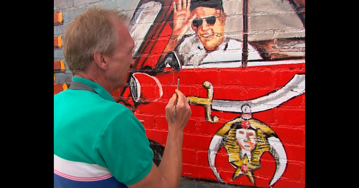 Dad paints payback mural for town who helped raise kids