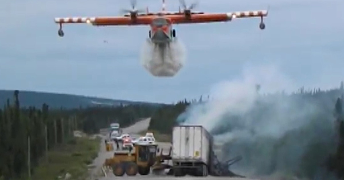 Water bomber plane puts out street fire in Canada