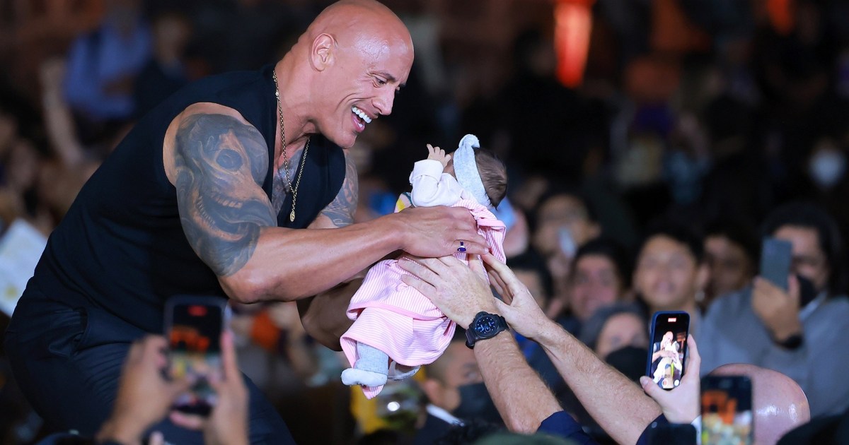 Watch dad crowd-surf his baby to The Rock at event in Mexico City