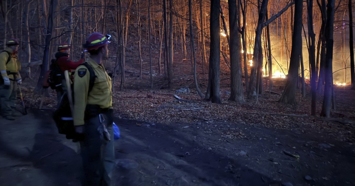 Firefighters begin to contain historic wildfire in the Northeast