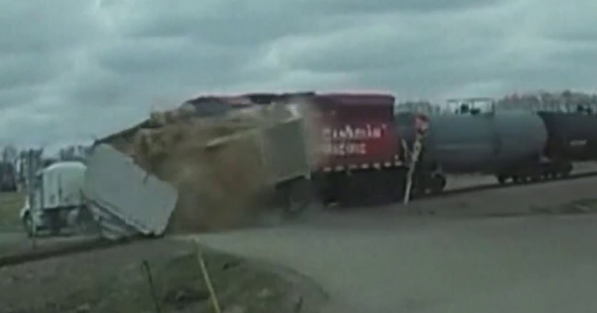 Freight train crashes into semitruck, splitting it in half