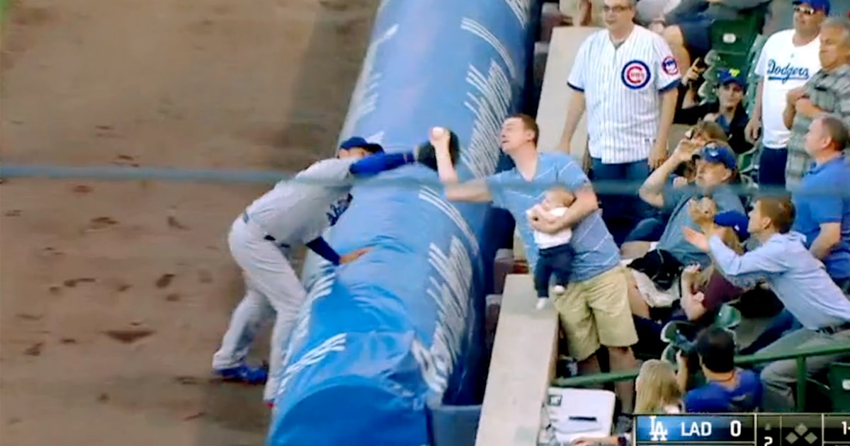 Dad makes amazing one-handed catch while holding his infant son