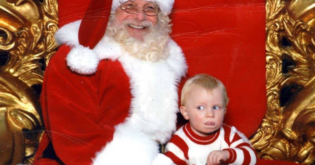 Baby signs 'help' to his mom from mall Santa's lap