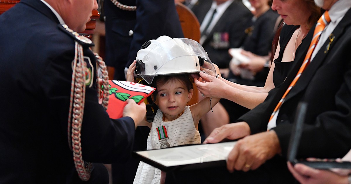 Aussie firefighter's daughter stays by his coffin in emotional scene