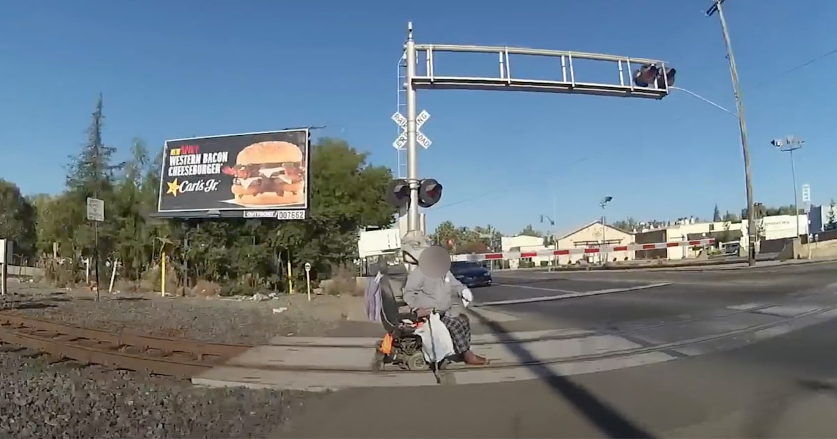 Video shows officer rescuing man in wheelchair from oncoming train