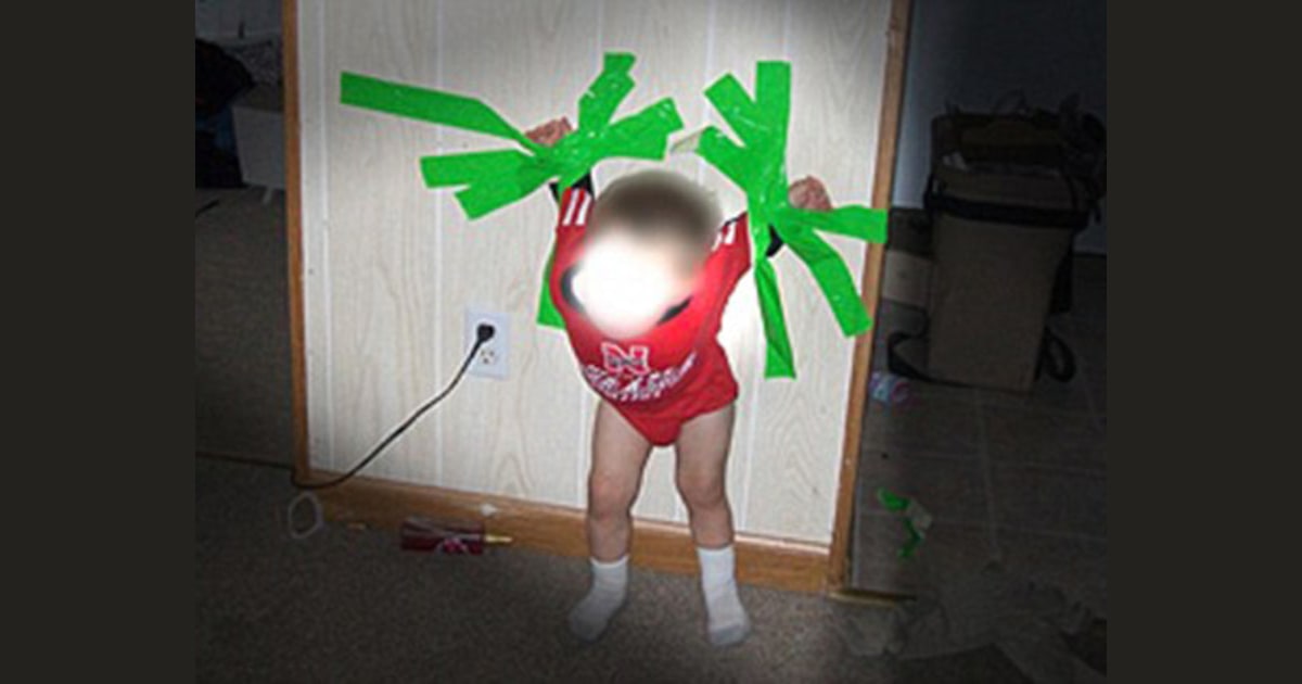 Couple duct-tapes toddler to a wall for amusement